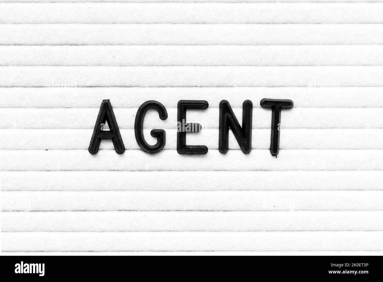 Black color letter in word agent on white felt board background Stock ...