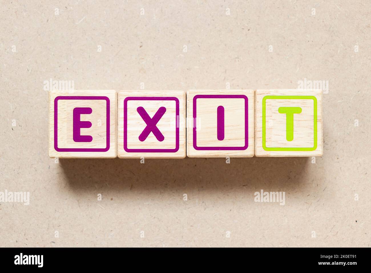 Color letter block in word exit on wood background Stock Photo - Alamy