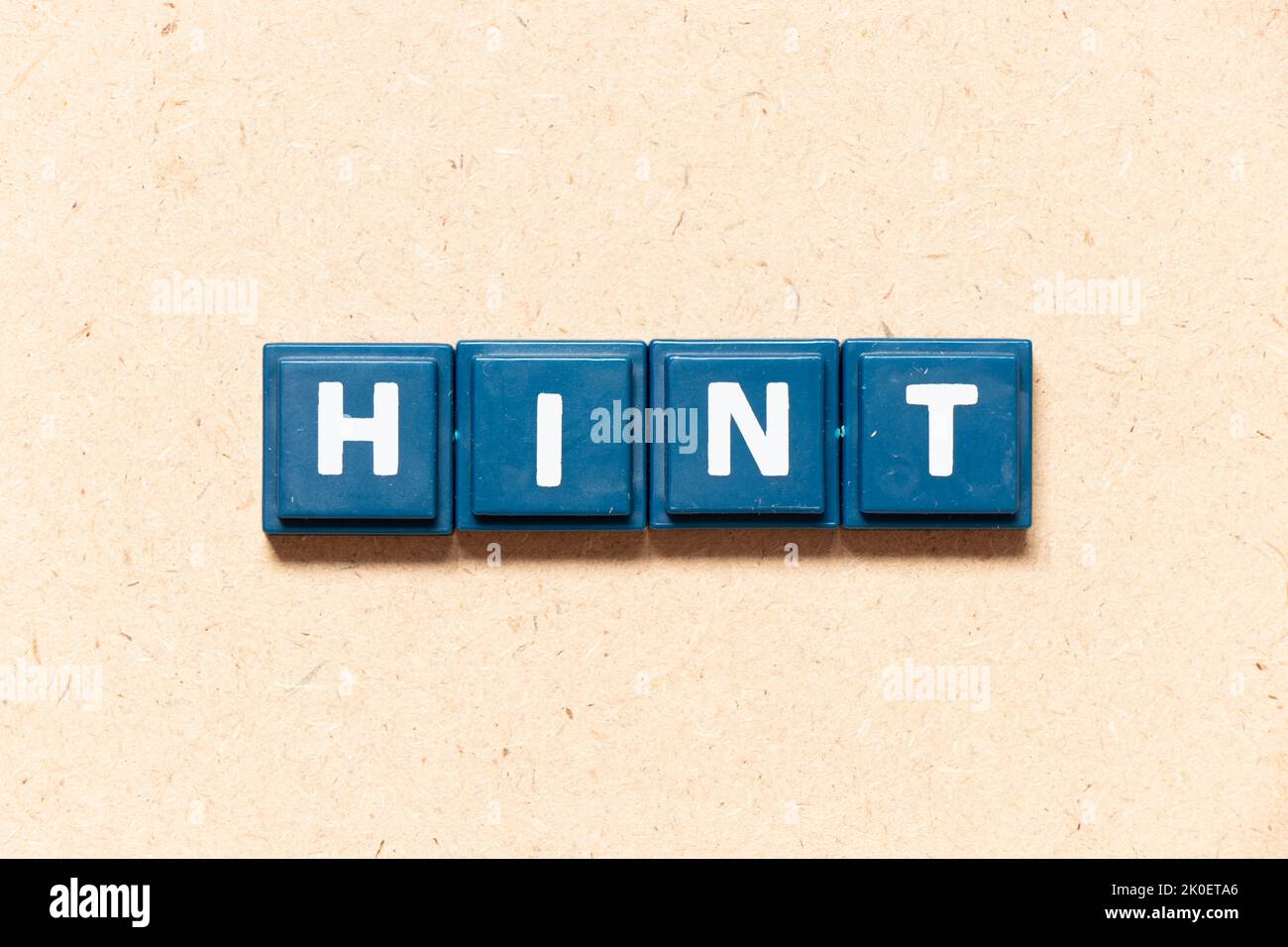 Tile letter in english word hint on wood background Stock Photo - Alamy