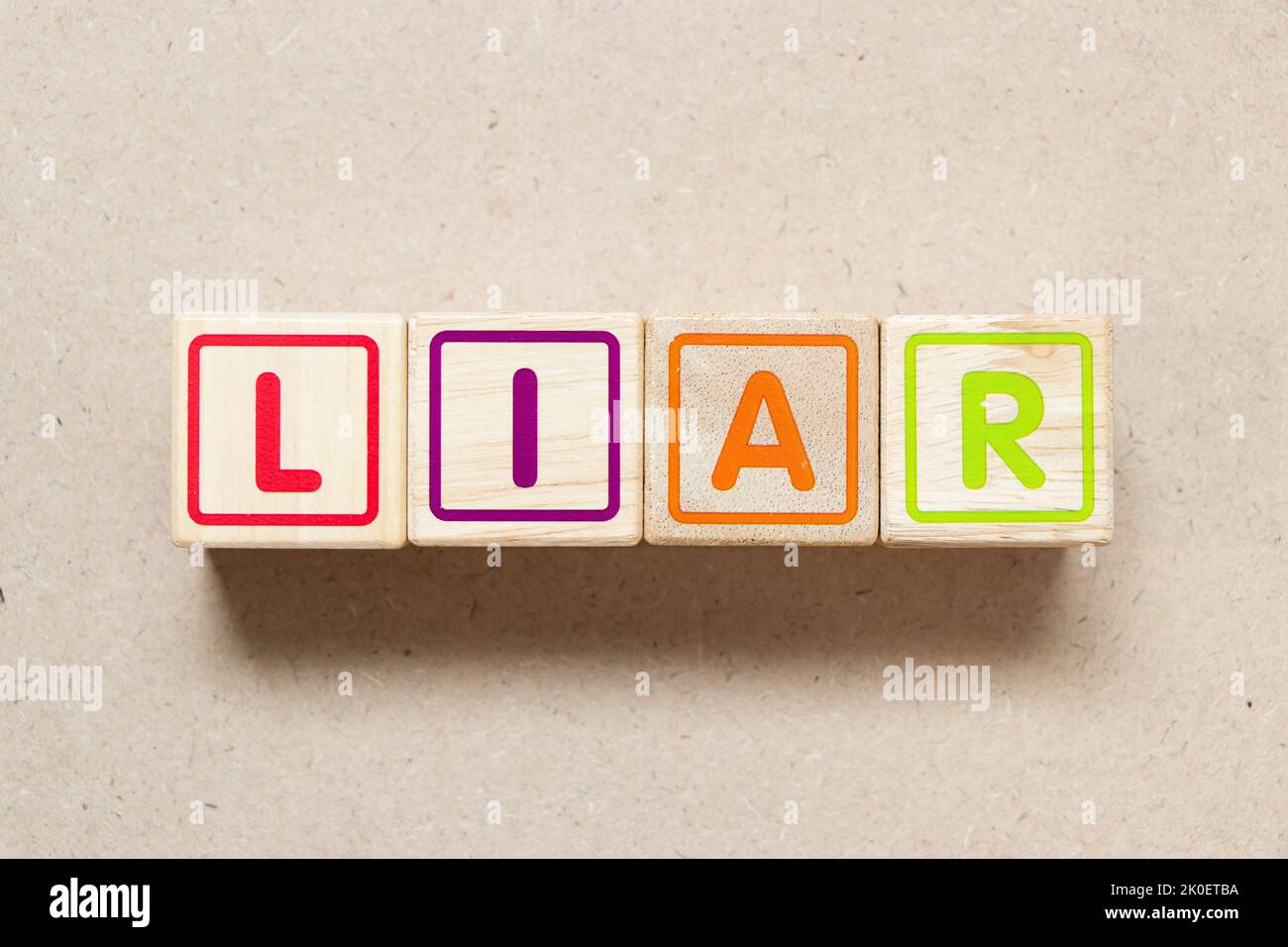 Color letter block in word liar on wood background Stock Photo - Alamy