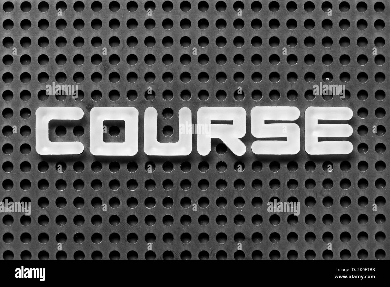 White alphabet letter in word course on black pegboard background Stock ...