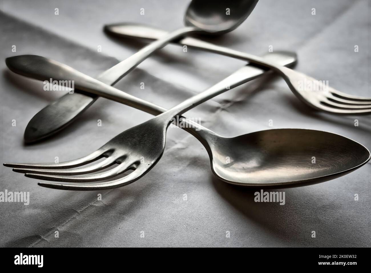 Black and white photography with intertwined spoons and forks Stock ...