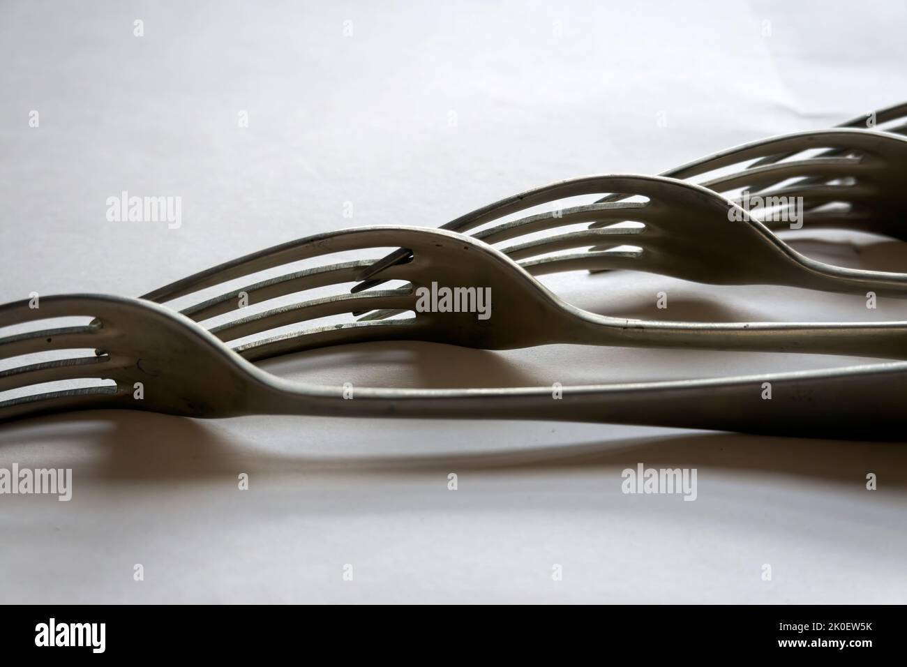 Close-up of linked forks on white background Stock Photo - Alamy