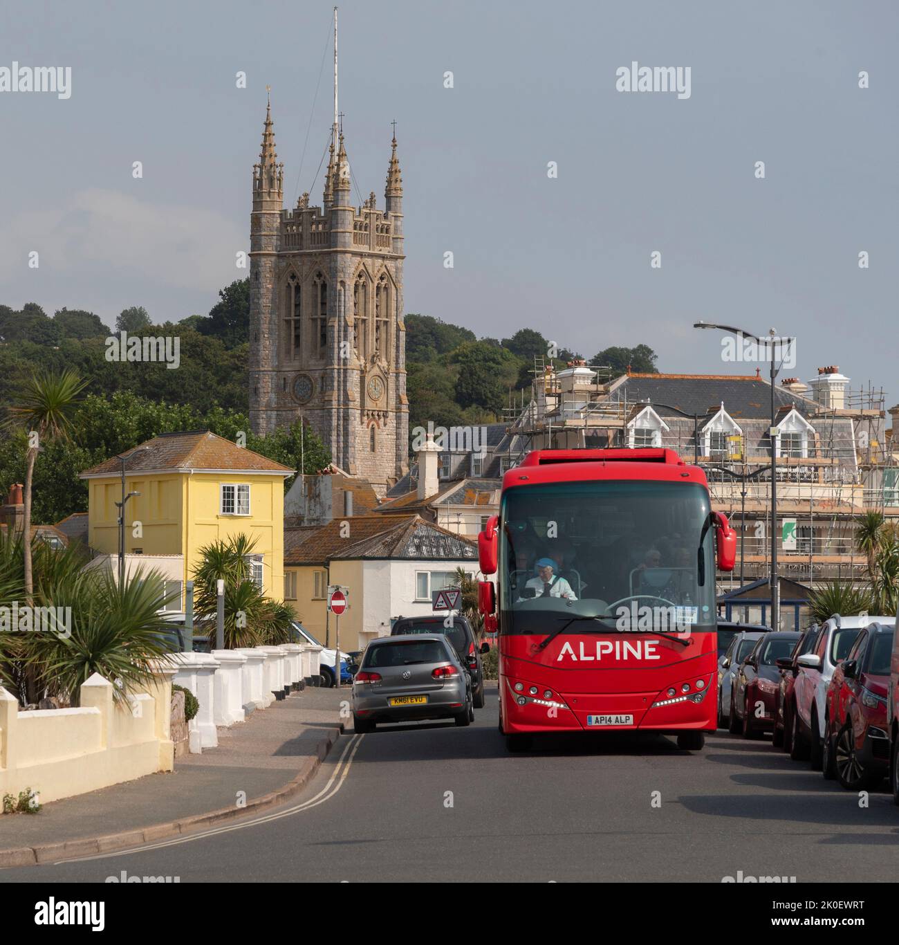Teignmouth, Devon, England, UK. 2022. Red touring coach driving through ...