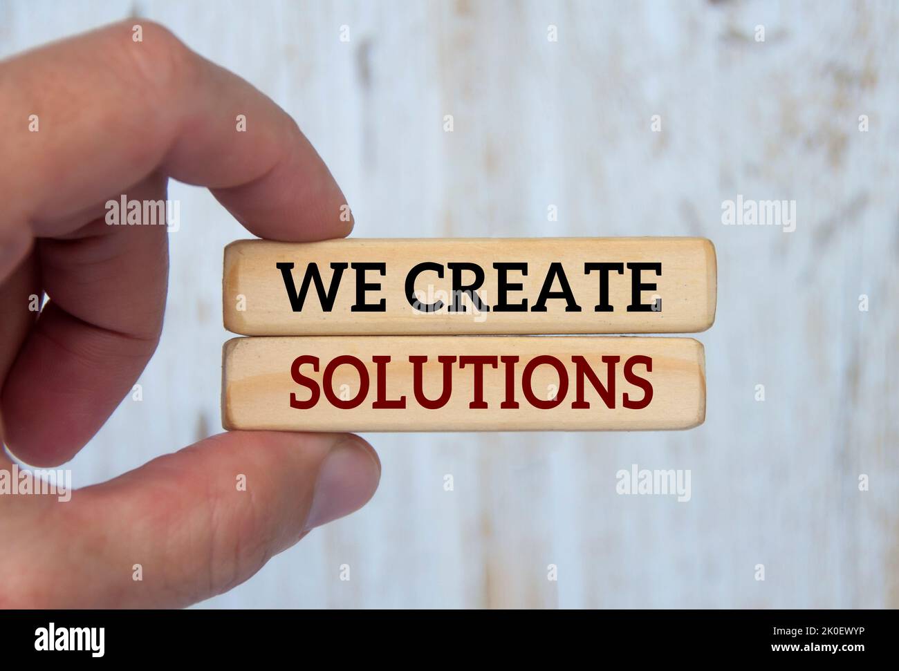 Hand holding wooden blocks with text - We create solutions. Problem ...
