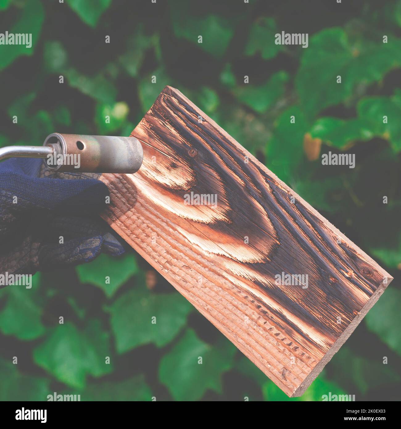 Professional carpenter using old traditional technique. Burning wood ...