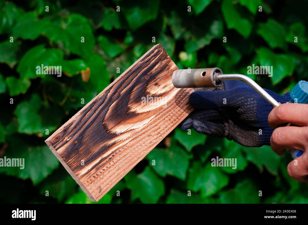 Professional carpenter using old traditional technique. Burning wood ...