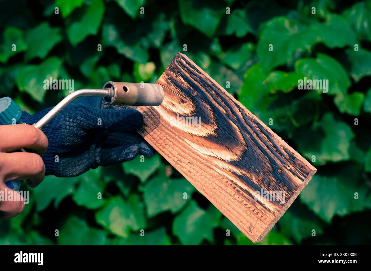 Professional carpenter using old traditional technique. Burning wood ...