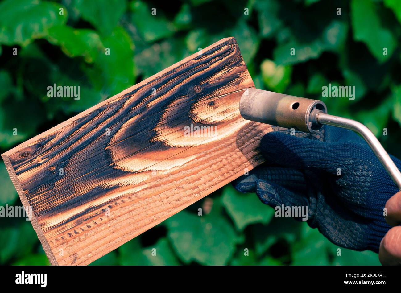 Professional carpenter using old traditional technique. Burning wood ...
