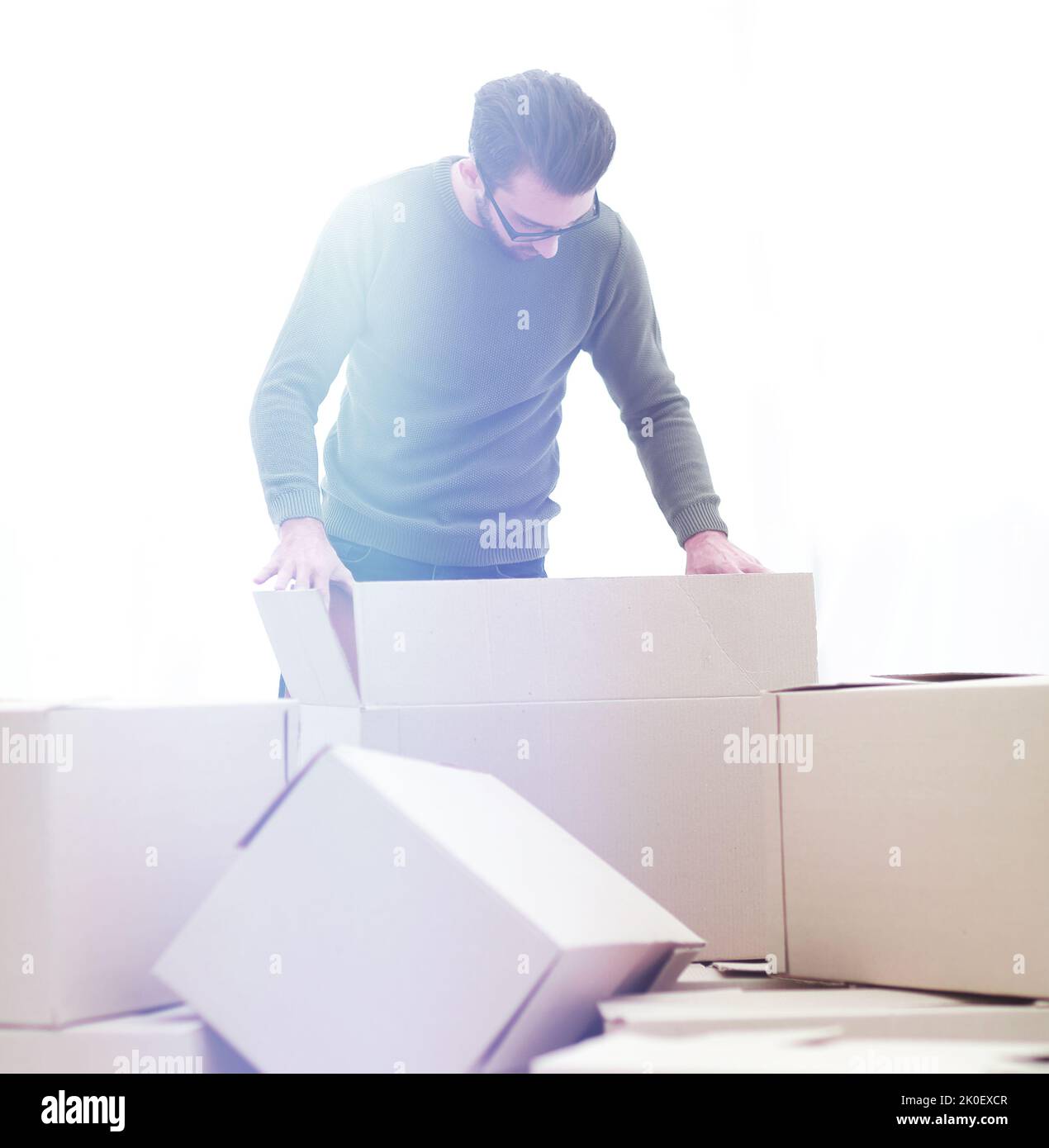 confident man unpacking boxes in the new house Stock Photo - Alamy