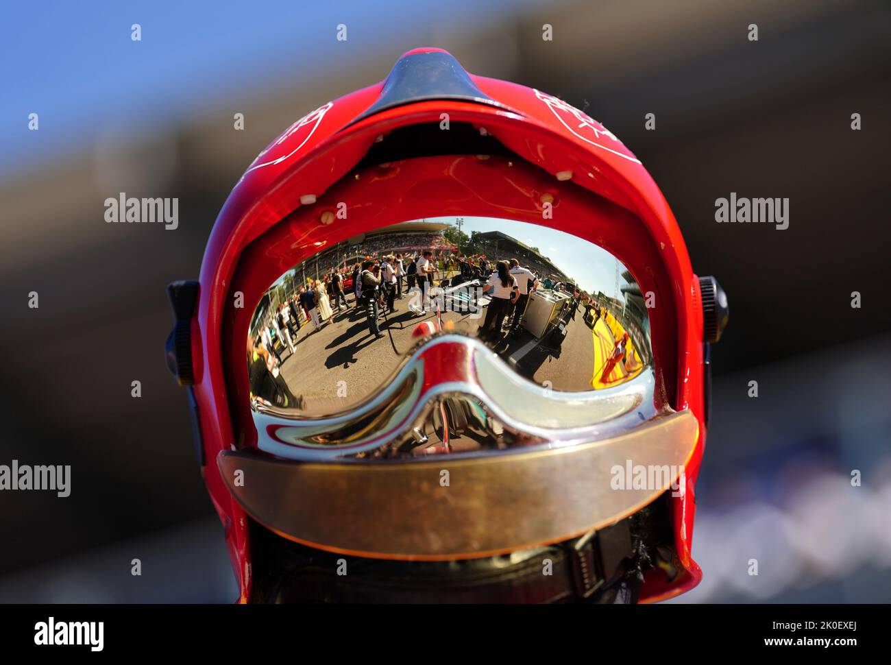 The reflection in the visor of a fire marshal on the grid before the ...