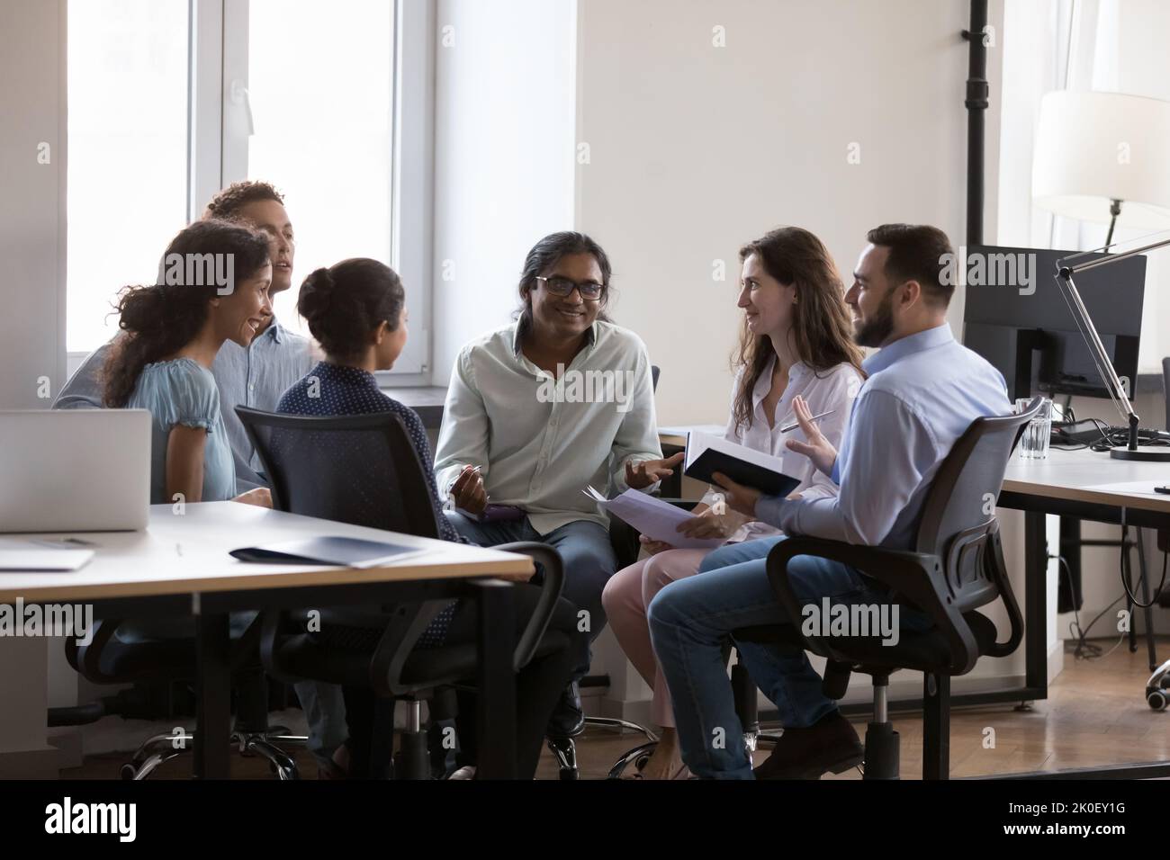 Happy millennial diverse team sitting in circle, training teambuilding ...