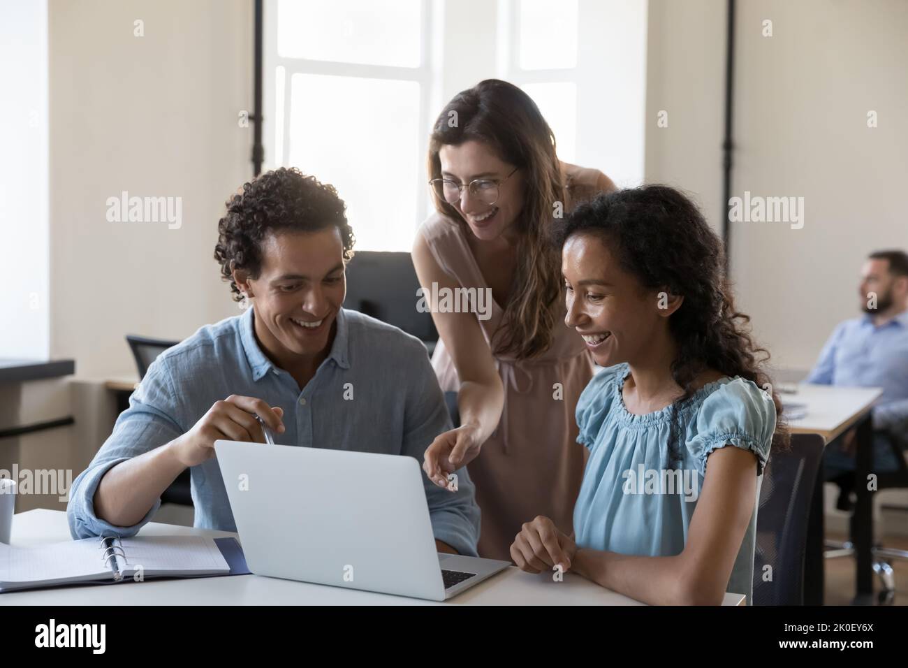 Happy cheerful startup team working at laptop computer together Stock ...