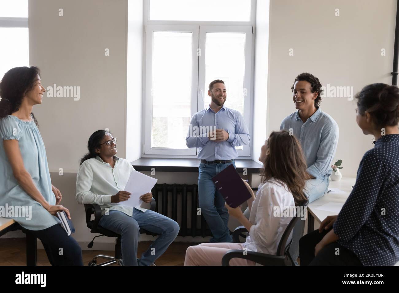 Cheerful coworkers meeting in open office space Stock Photo - Alamy