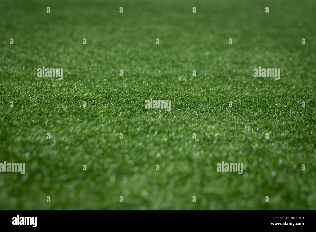 Green football grass background. Focus in the center and blurry sides ...
