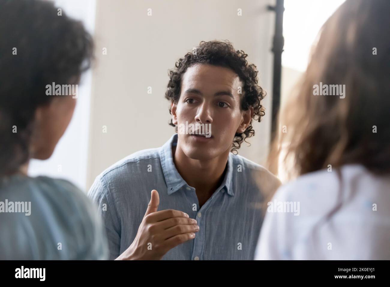 Serious motivated business team employee talking to coworkers Stock ...