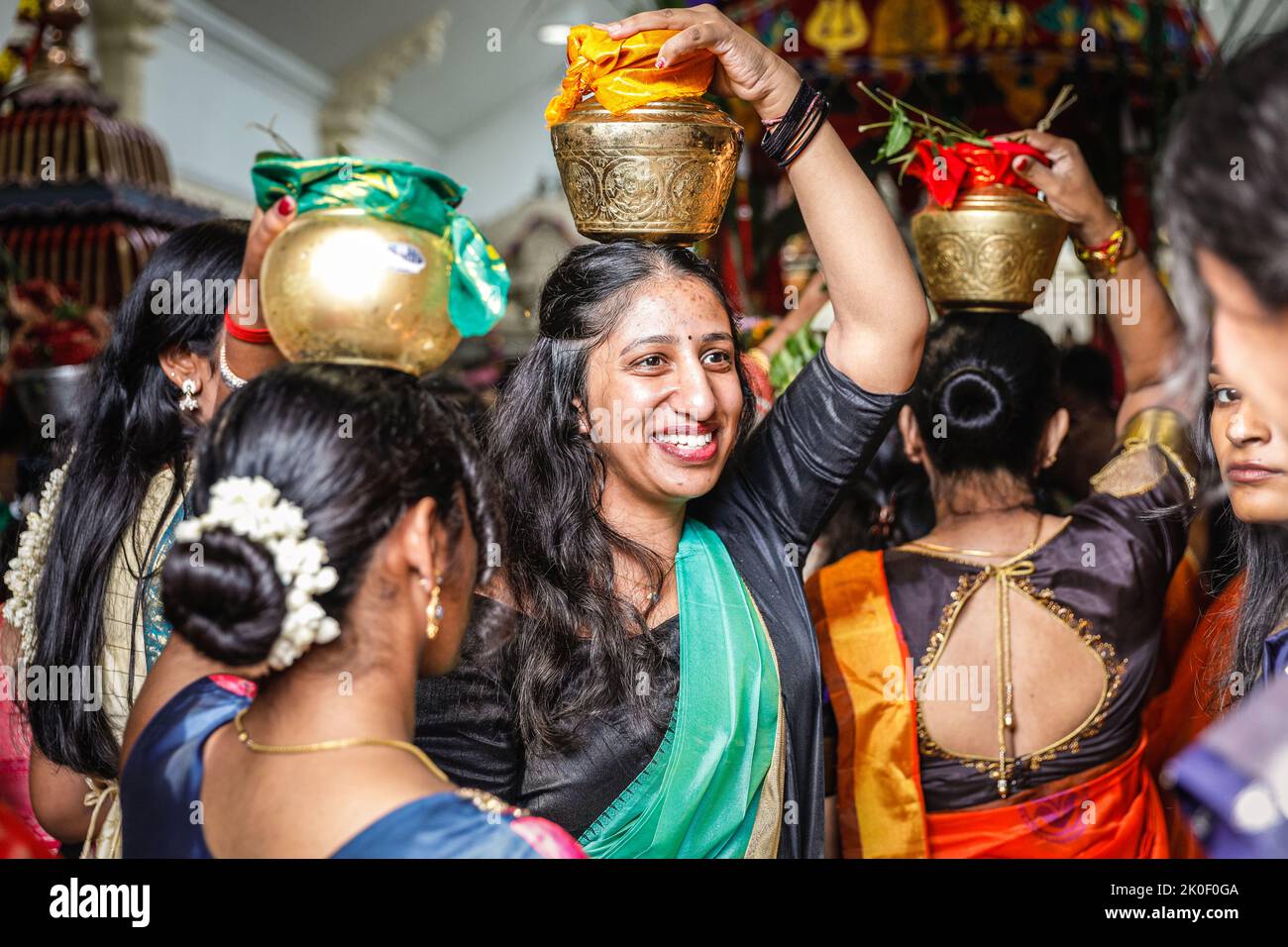 Lewisham, London, UK. 11th Sep, 2022. Many women hold pots filled with ...