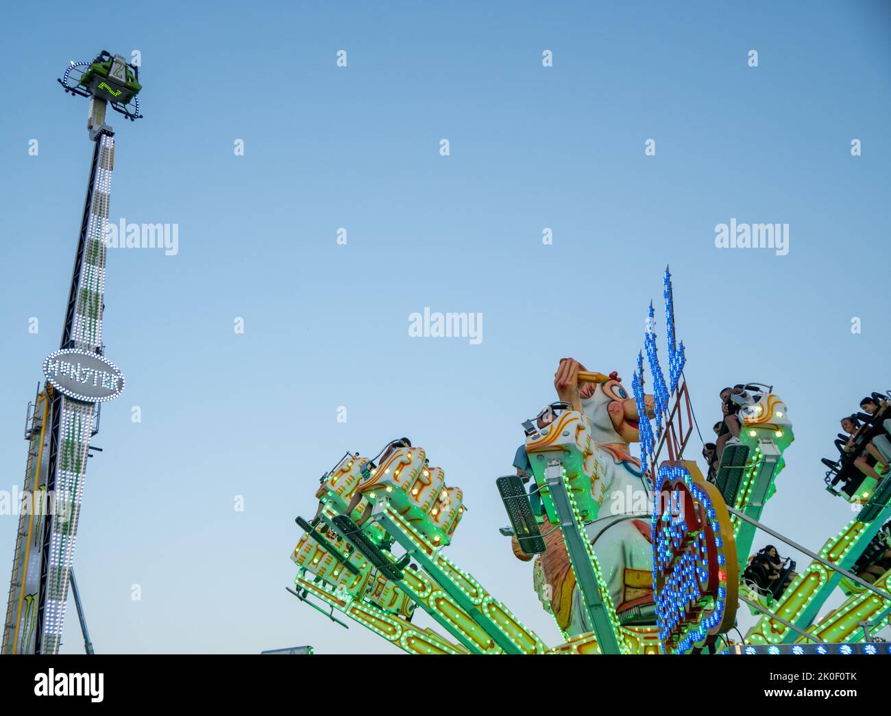 Group of people laughing and enjoying a funfair ride at full speed in ...