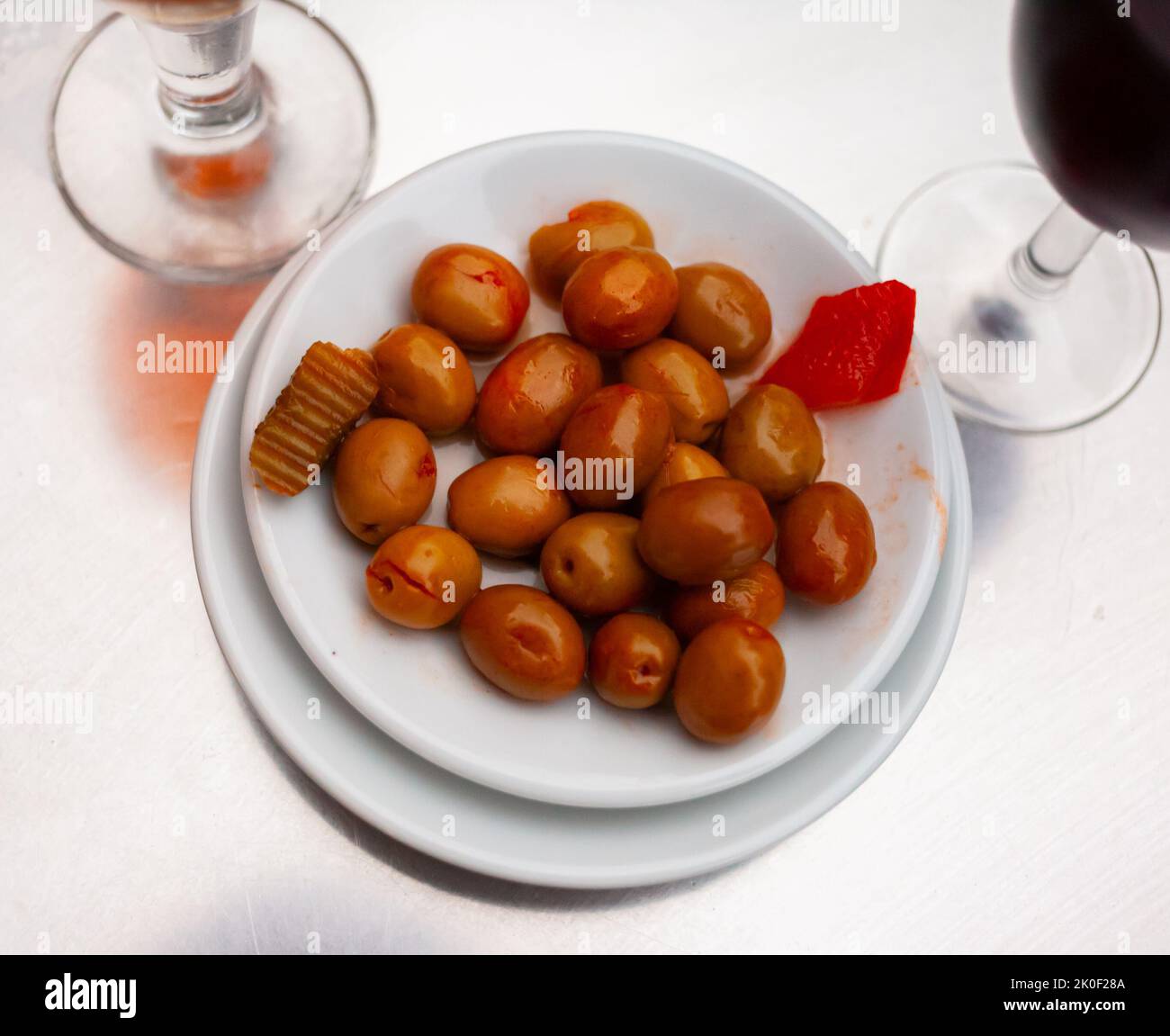 Marinated olives with pits - Spanish tapas Stock Photo - Alamy