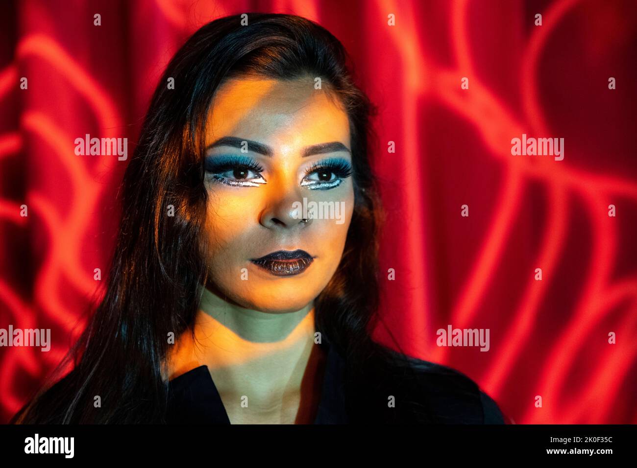Female circus girl portrait with light shadows across her face and ...