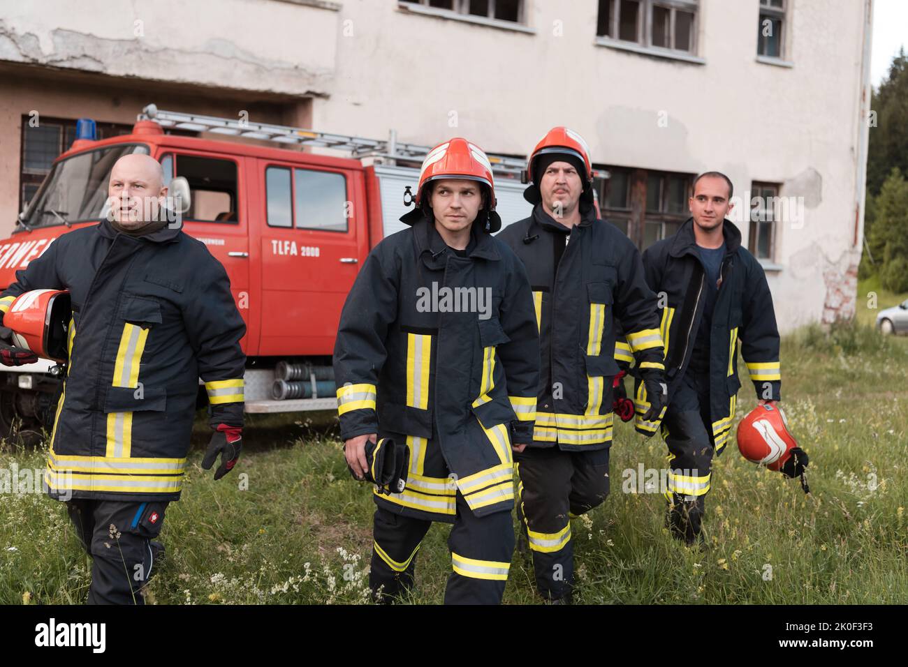 Group of fire fighters standing confident after a well done rescue ...