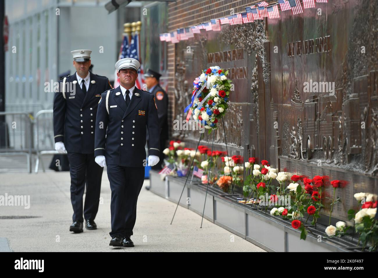 Firefighters salute each other as they stand guard at the FDNY Memorial ...