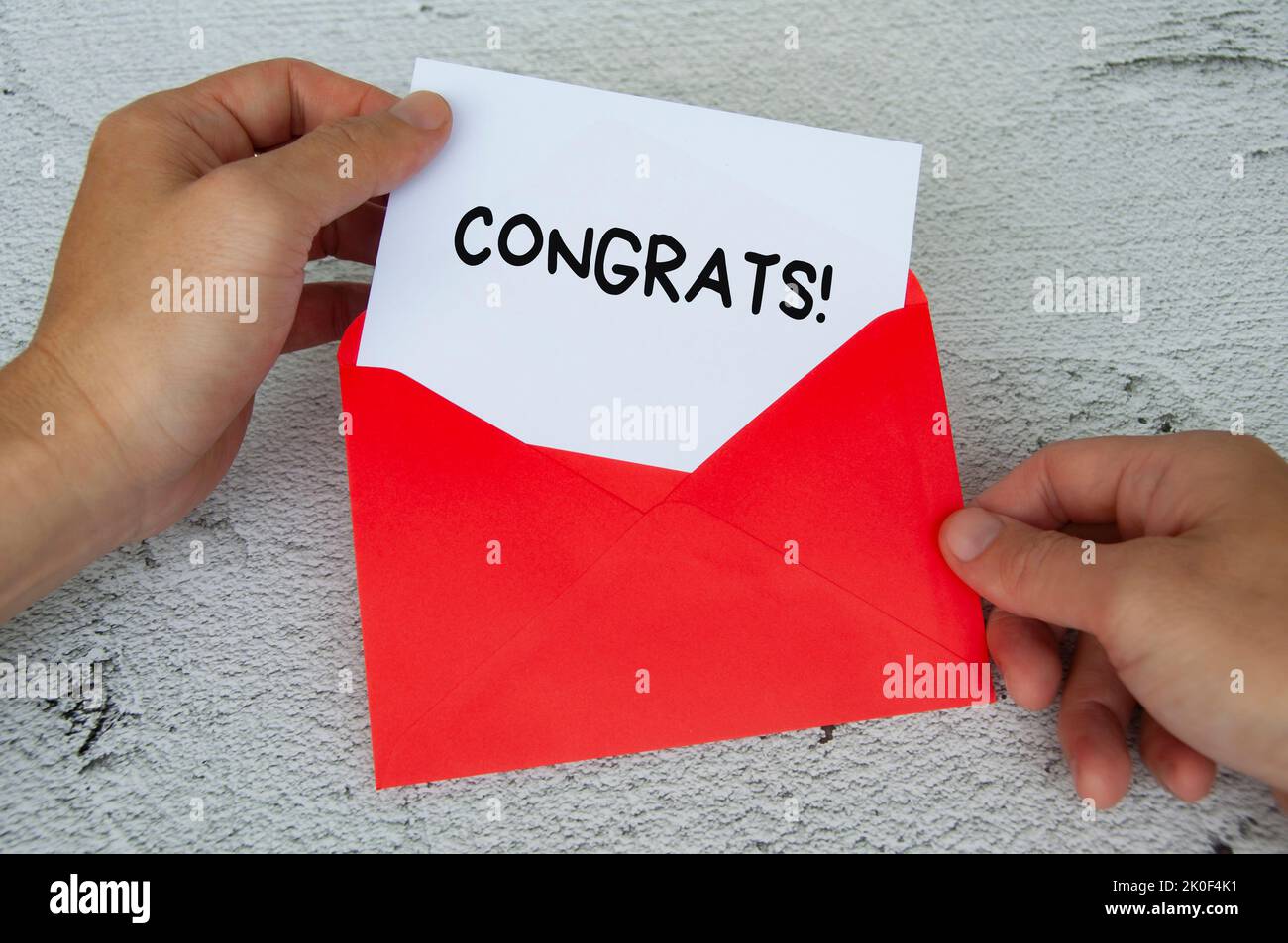 Congrats text on white notepad in red envelope. Appreciation concept ...