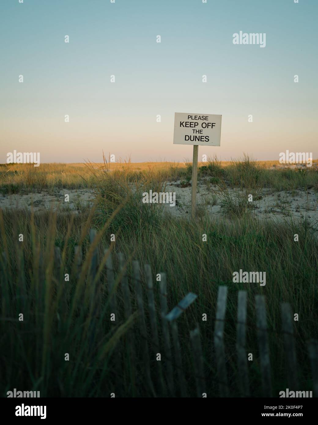 Sand dunes and fence with "keep off the dunes" sign, Fire Island, New ...