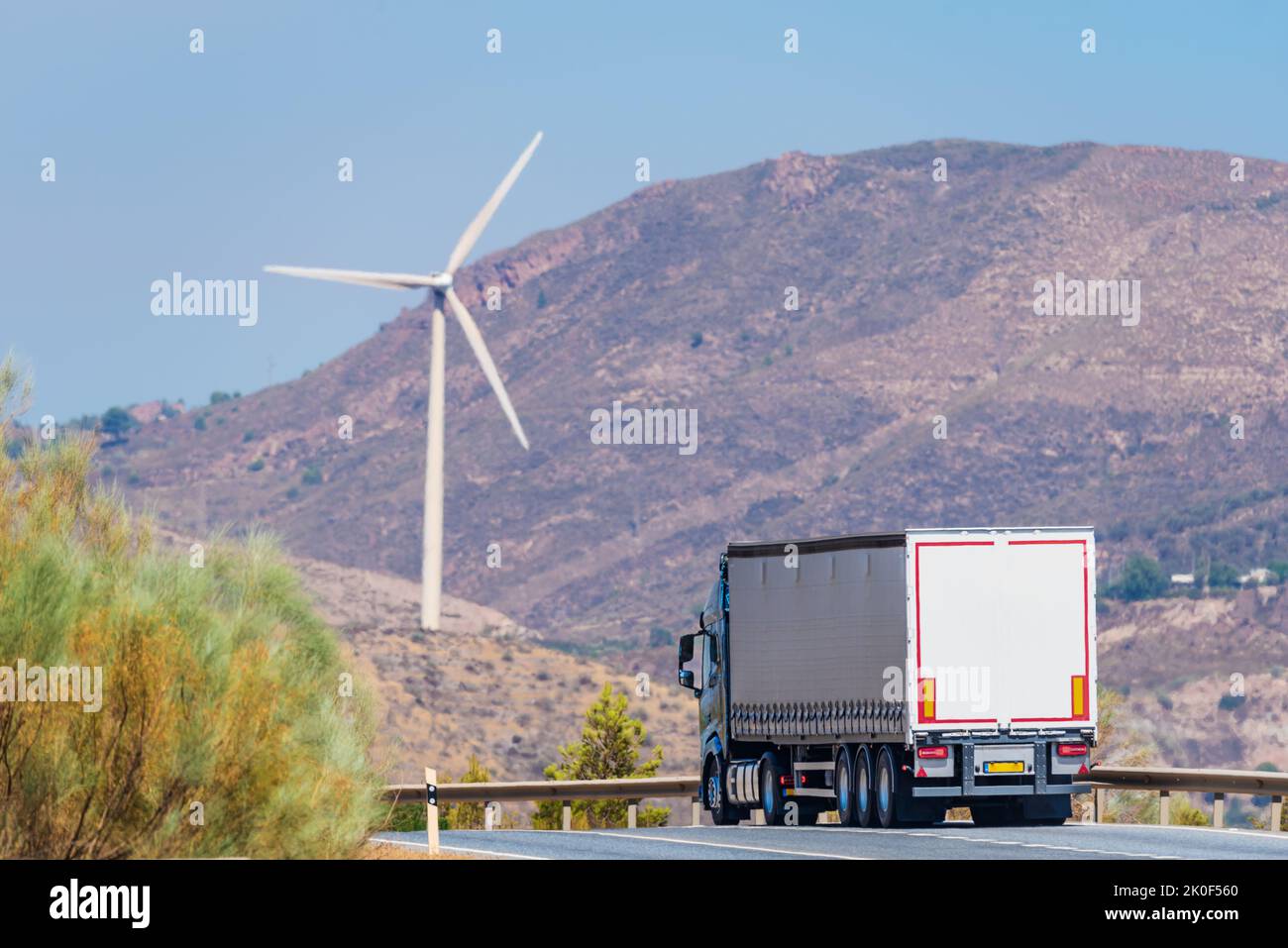 Truck with tarpaulin semi-trailer for general cargo driving along a ...