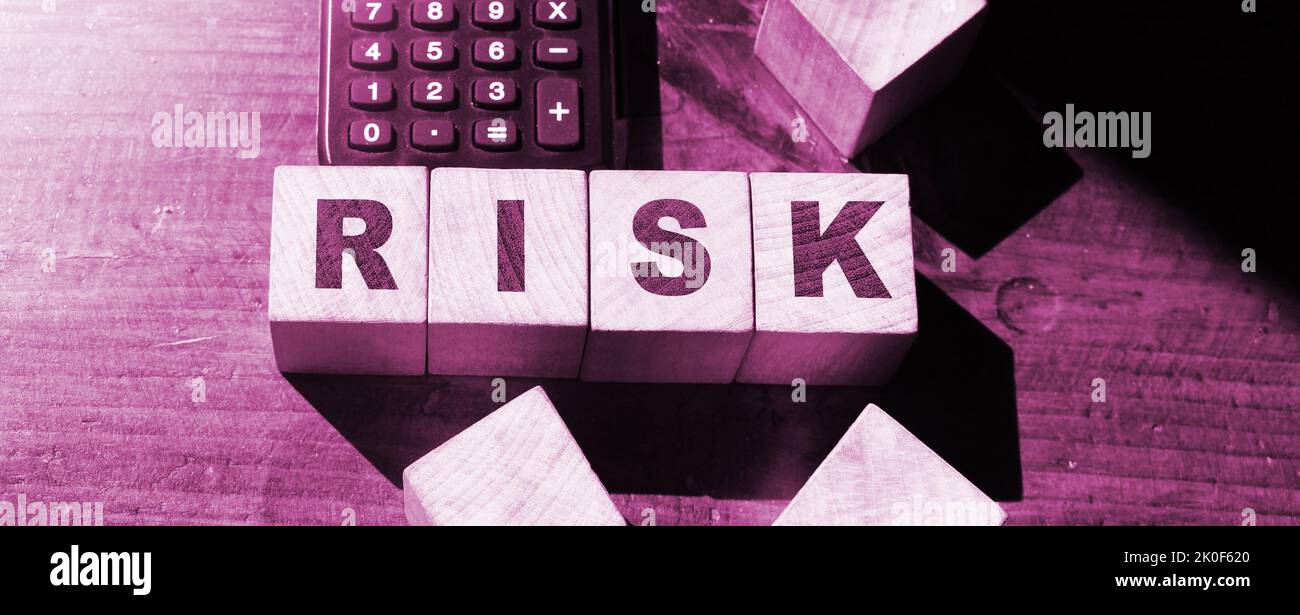 RISK word written on wooden cubes and calculator. Financial risk ...