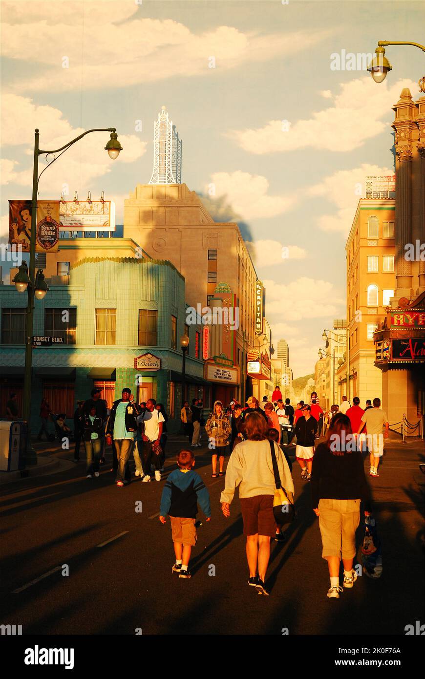 Tourists walk towards a realist looking back drop of a 1930's Hollywood ...