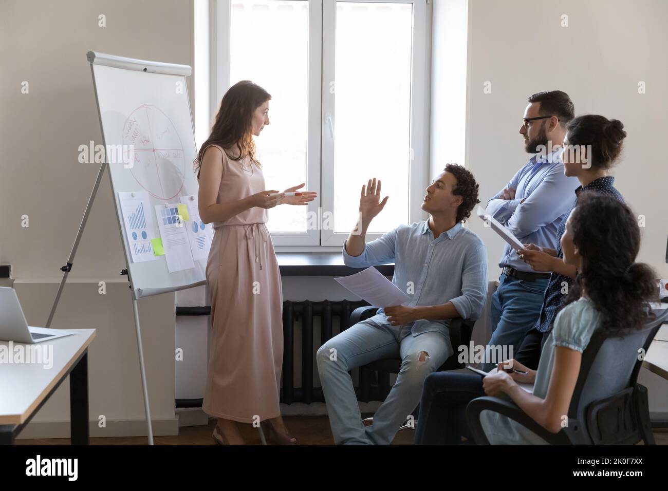 Business teacher woman giving presentation to diverse interns Stock ...
