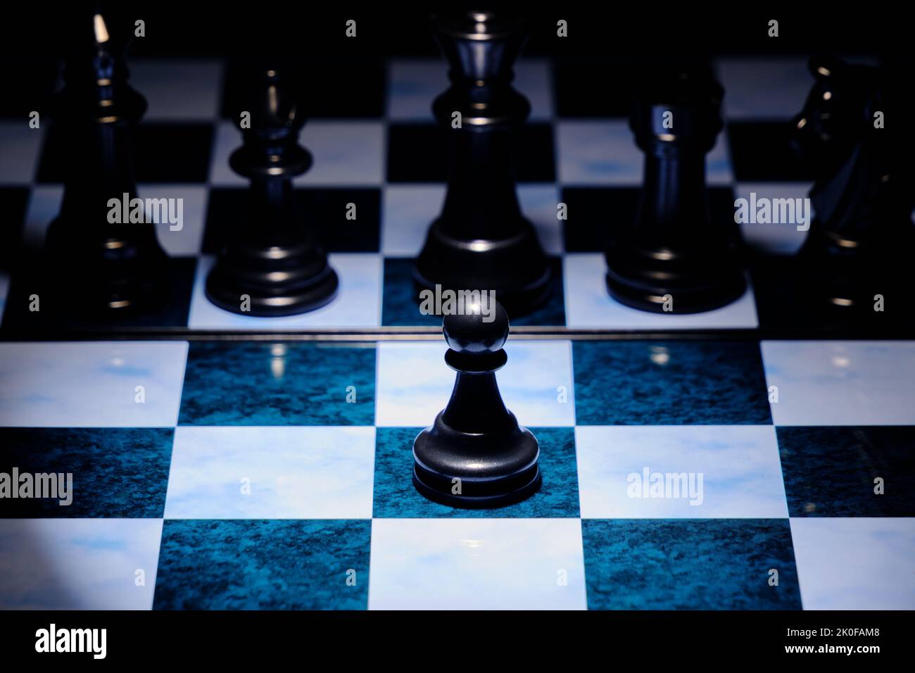 Chess pieces around pawn on chess board Stock Photo - Alamy