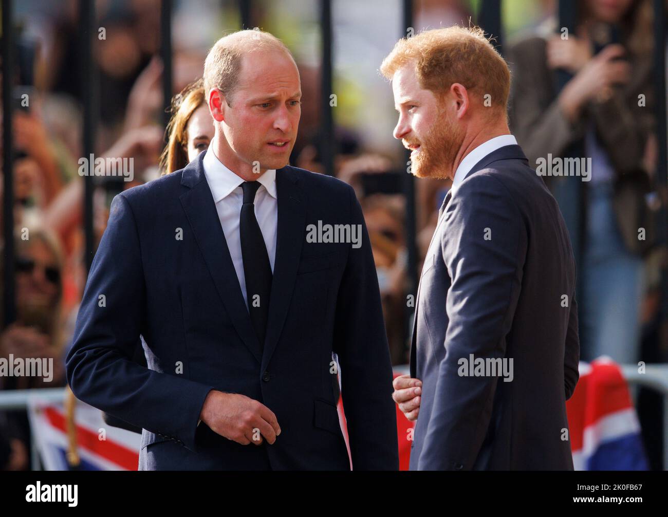 William Prince of Wales and Harry, Duke of Sussex look at flowers on ...