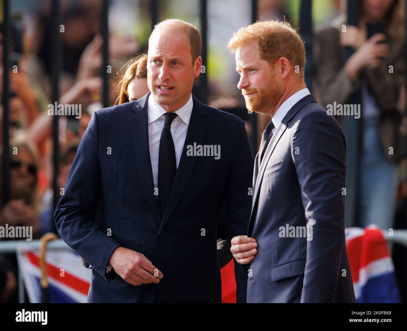 William Prince of Wales and Harry, Duke of Sussex look at flowers on ...