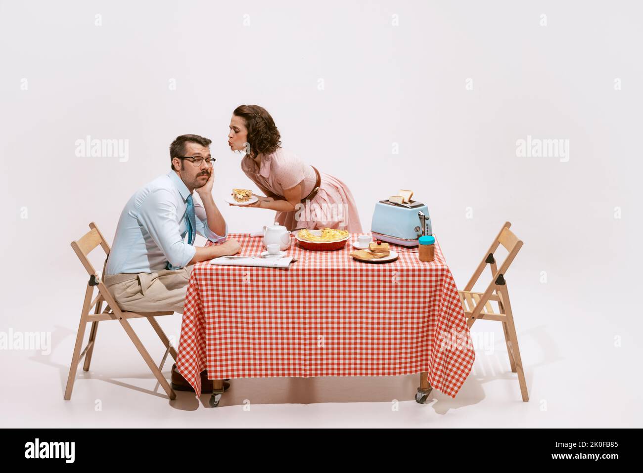 Portrait of loving couple sitting at the table, having breakfast ...