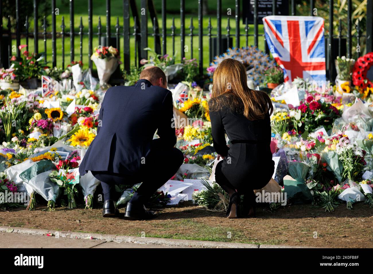 William Prince of Wales and Catherine Princess of Wales look at flowers ...