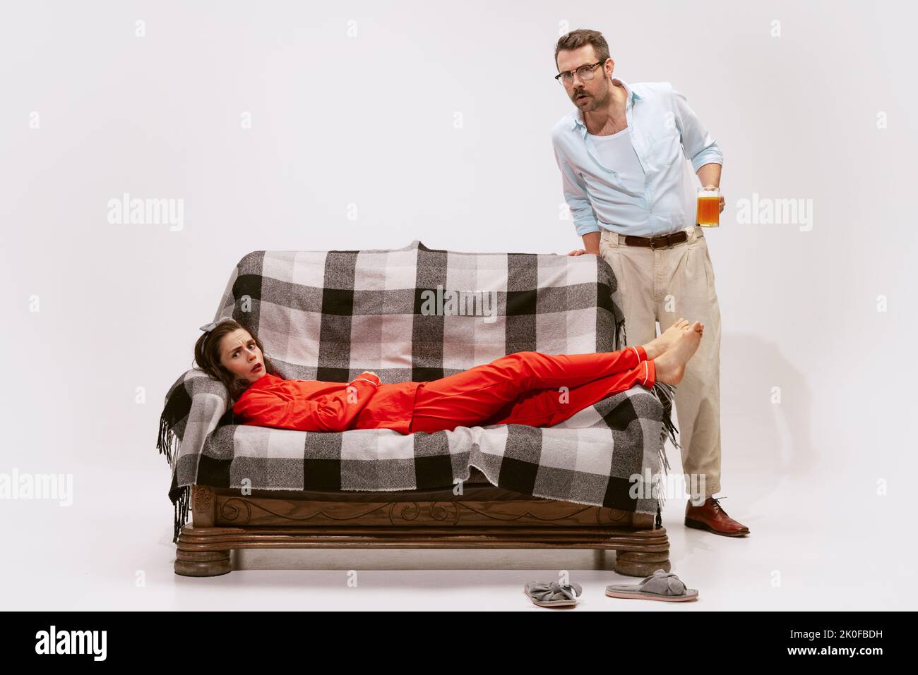 Portrait of emotive couple watching horror movie together. Woman lying ...