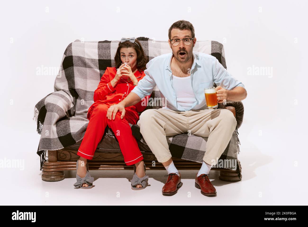 Portrait of couple, man and woman watching TV, movie together isolated ...