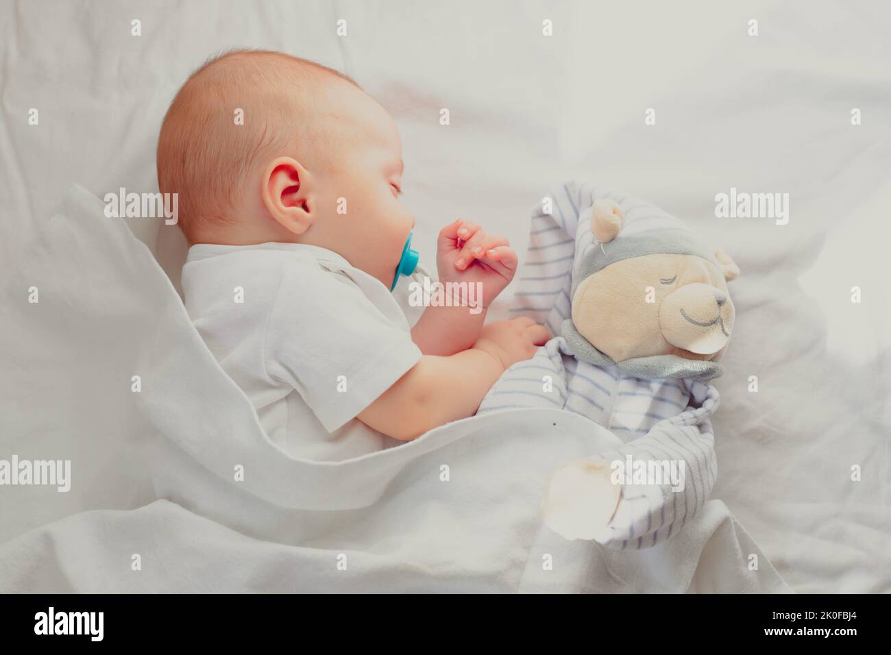 The baby is sleeping in his crib. Happy baby dream. A happy child ...