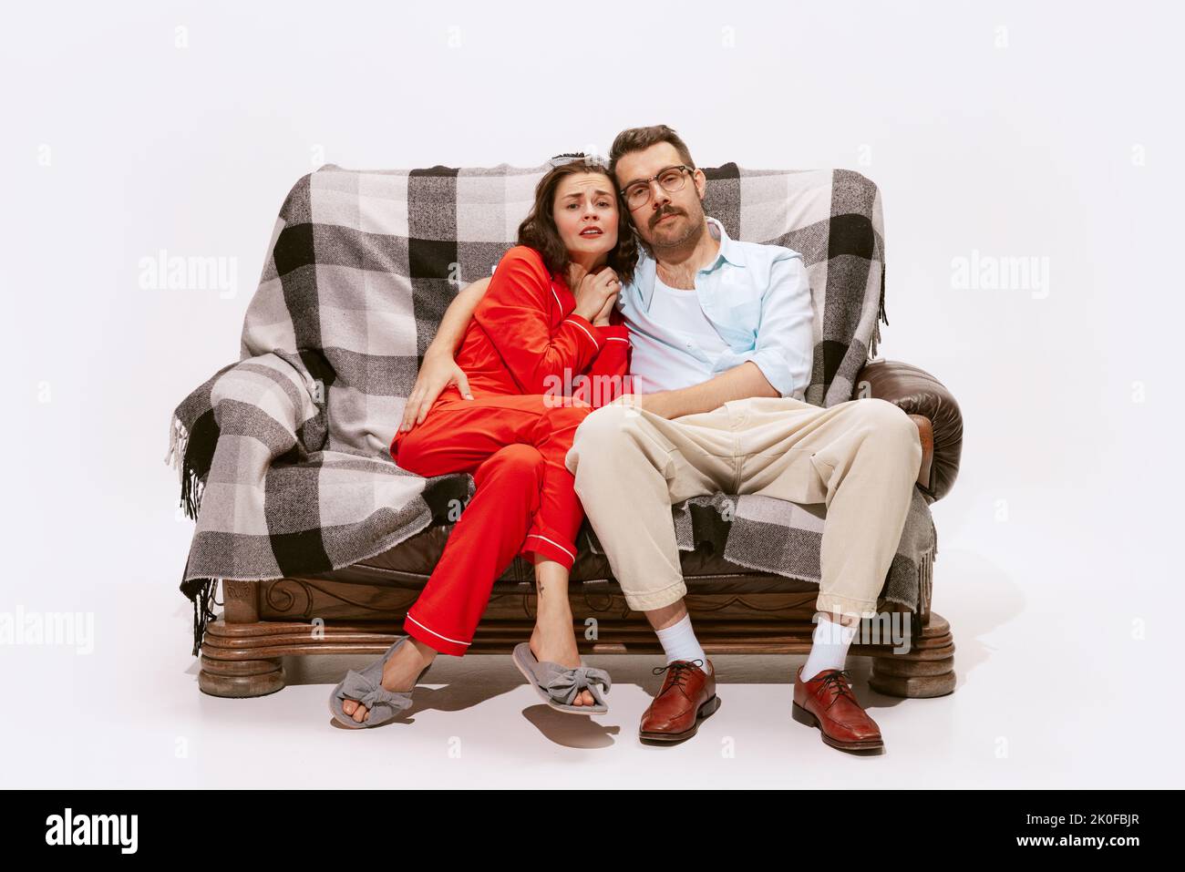 Portrait of couple, man and woman watching TV, movie together with ...