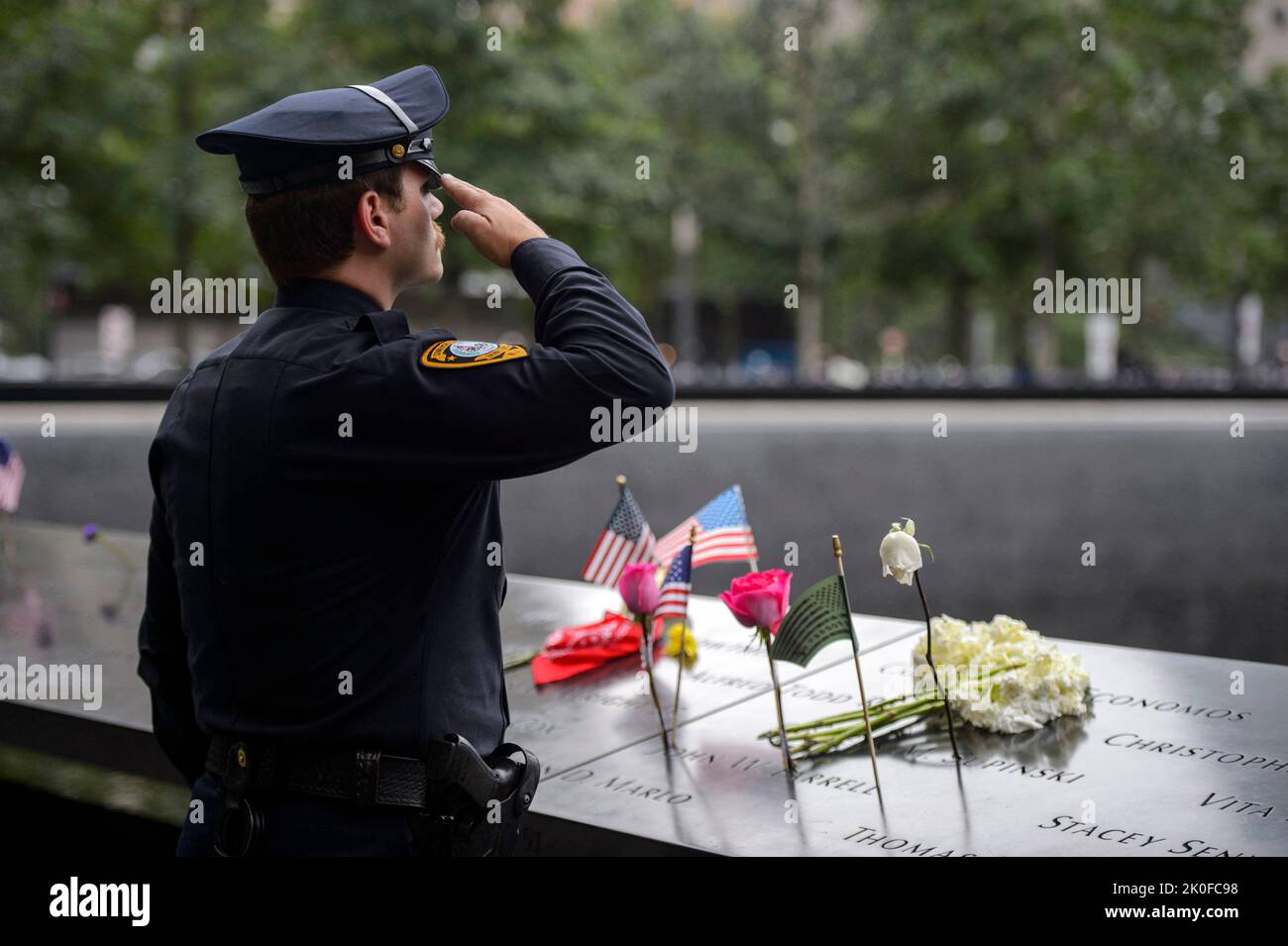 A service member pays respects at the National September 11th Memorial ...
