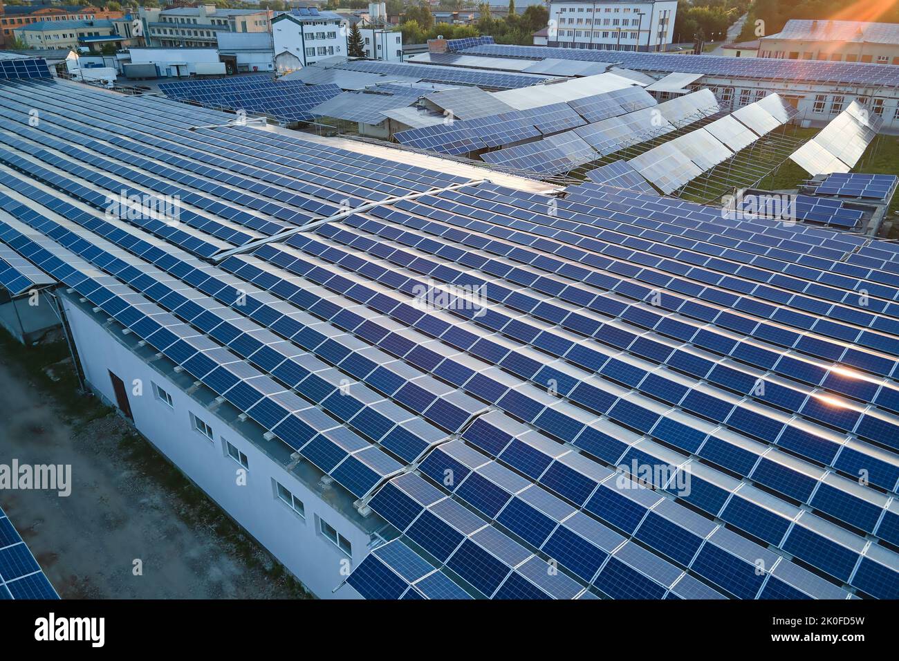 Aerial view of blue photovoltaic solar panels mounted on industrial ...