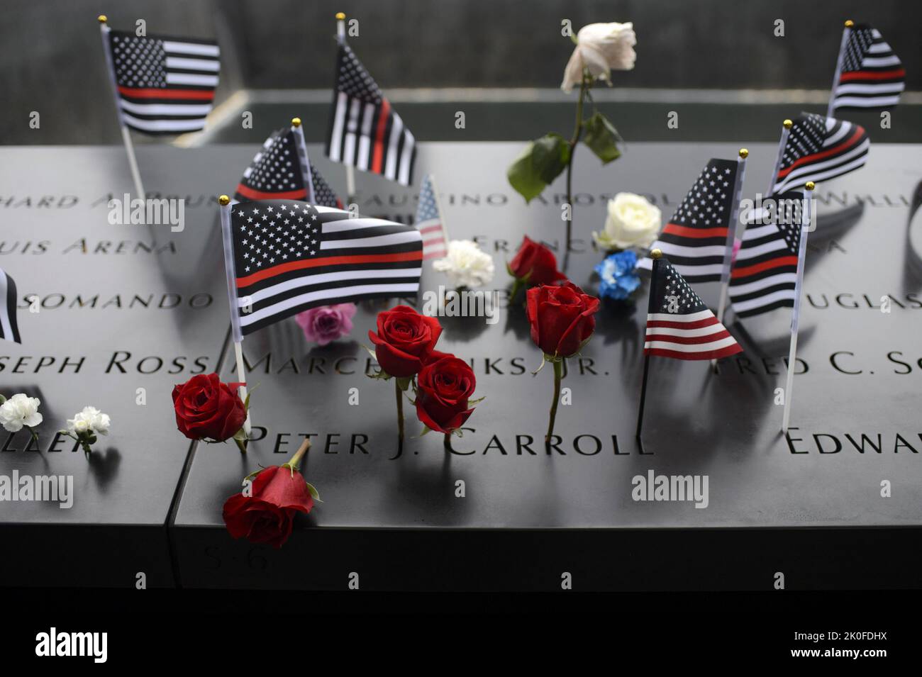 New York, United States. 11th Sep, 2022. Flowers and flags stand in ...
