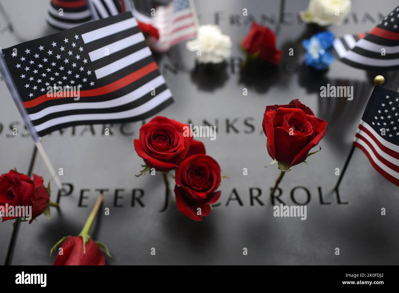 New York, United States. 11th Sep, 2022. Flowers and flags stand in ...