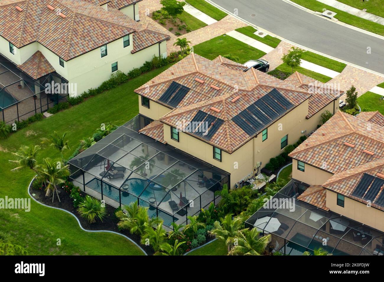 Aerial view of expensive modern houses with outside swimming pool ...