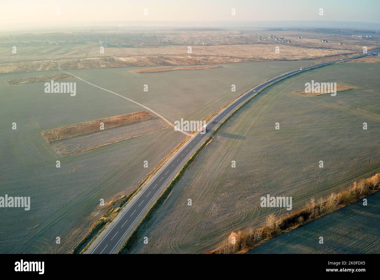 Aerial view of intercity road with fast driving cars at sunset. Top ...
