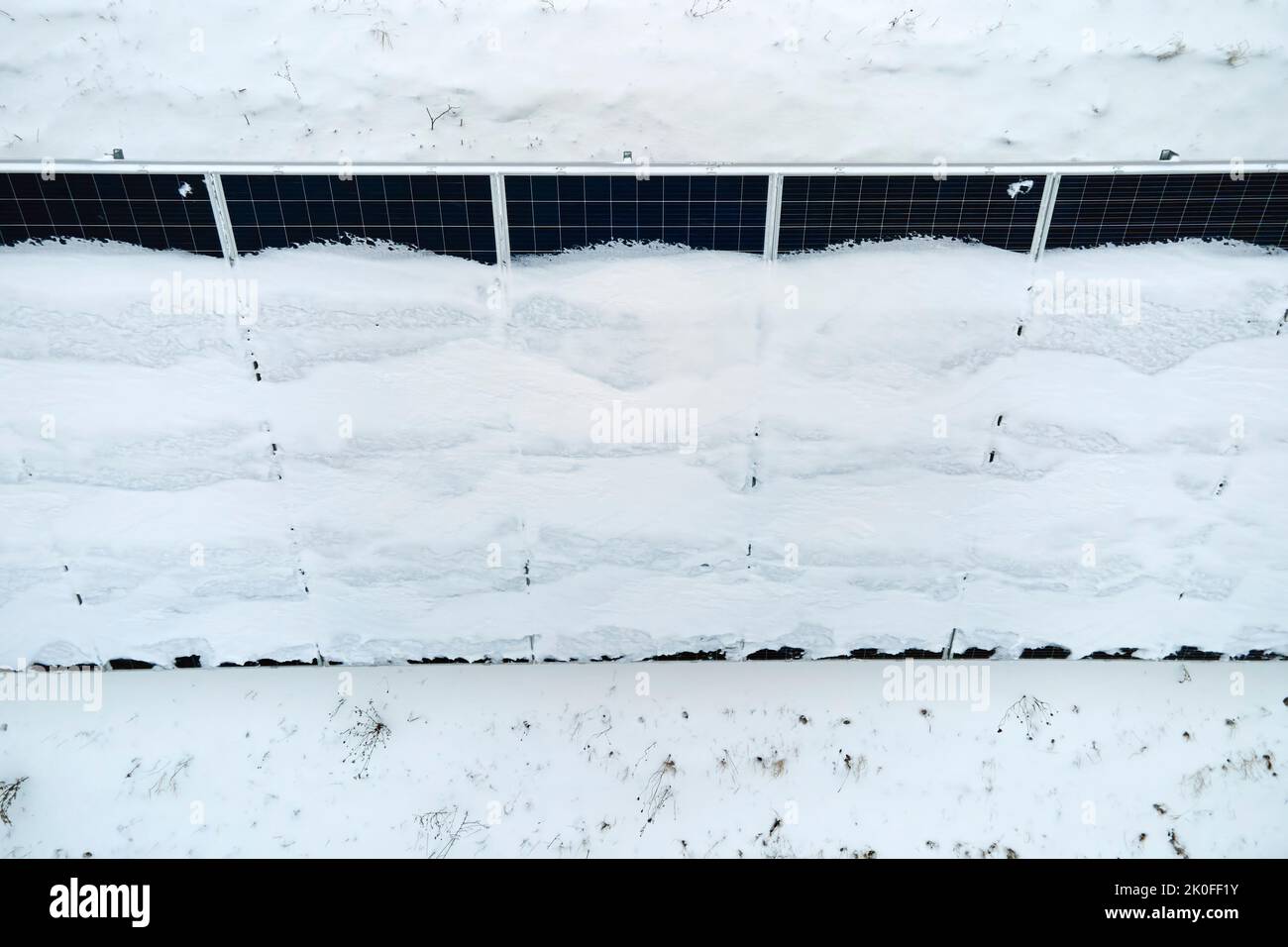 Aerial view of snow melting from covered solar photovoltaic panels at ...