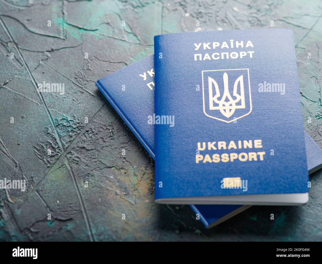 Close-up. Two Ukrainian biometric passports on a dark background ...