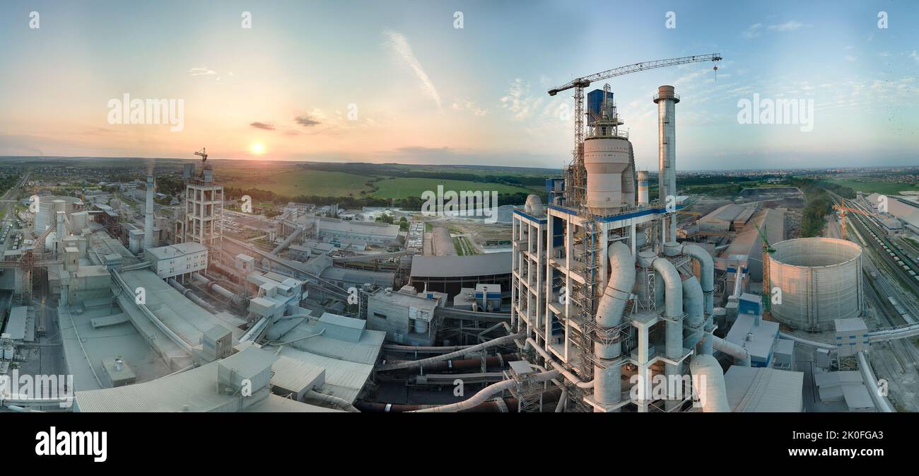 Cement plant with high factory structure and tower cranes at industrial ...
